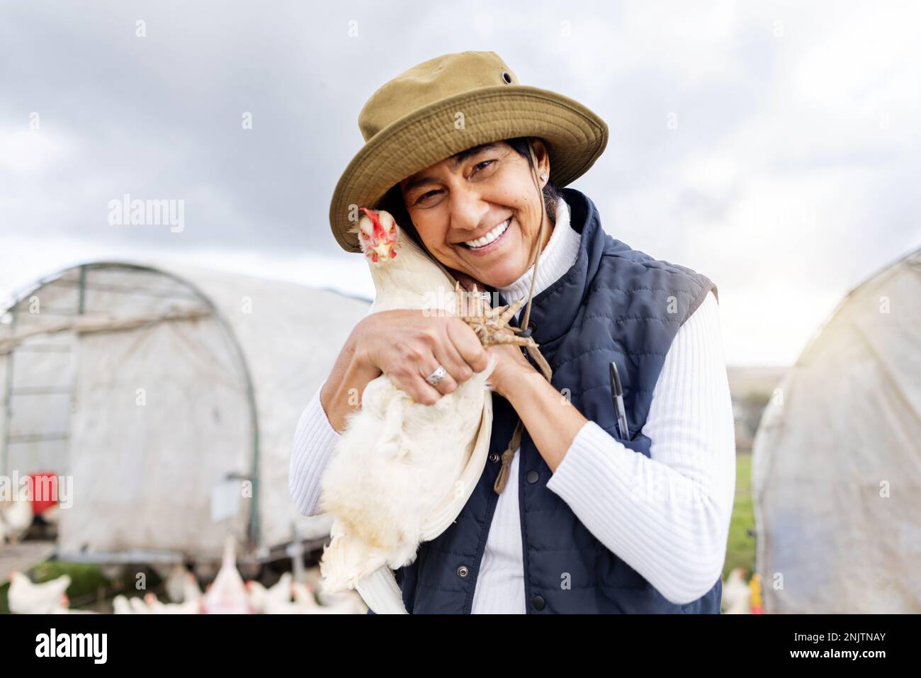 Chicken farmer, woman and smile for agriculture in field, environment ...