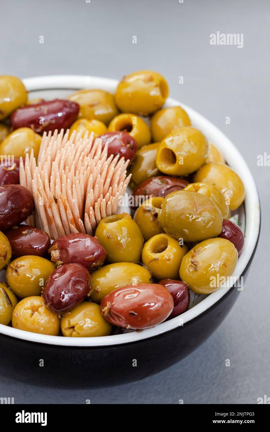 Mixed marinated olives in cocktail bowl on gray Stock Photo - Alamy
