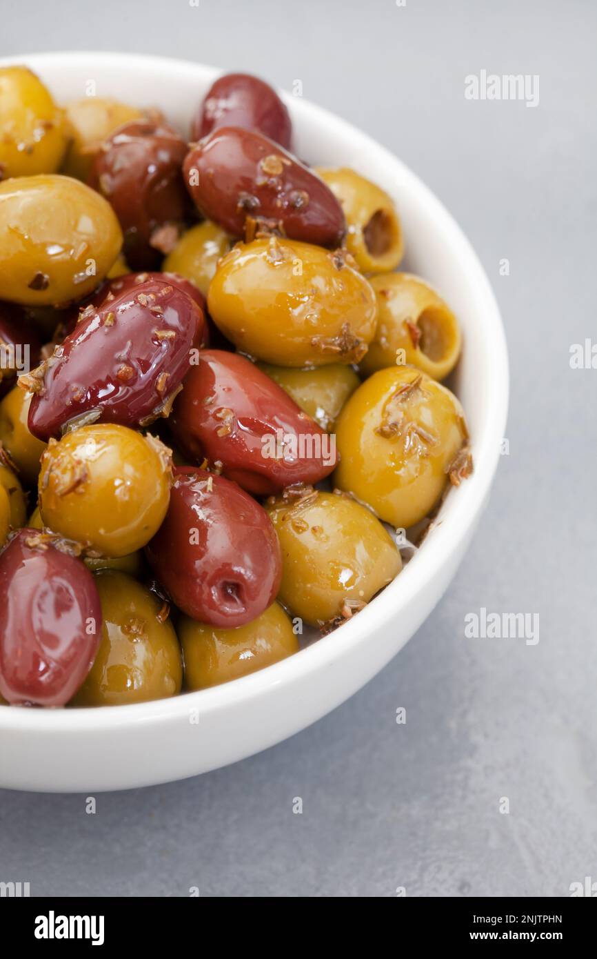 Mixed marinated olives on grey surface with copy space Stock Photo - Alamy