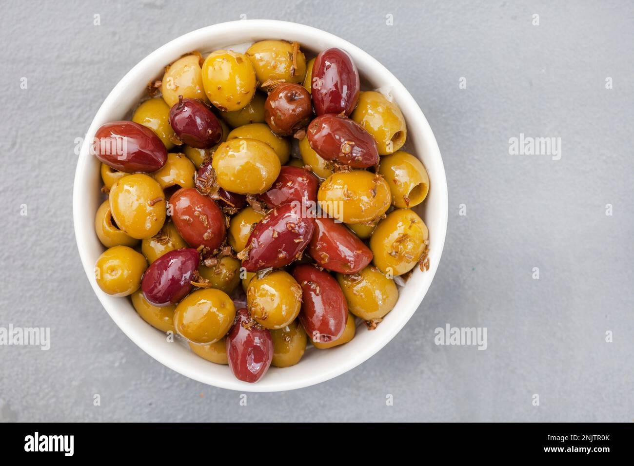 Mixed marinated olives on grey surface with copy space Stock Photo - Alamy