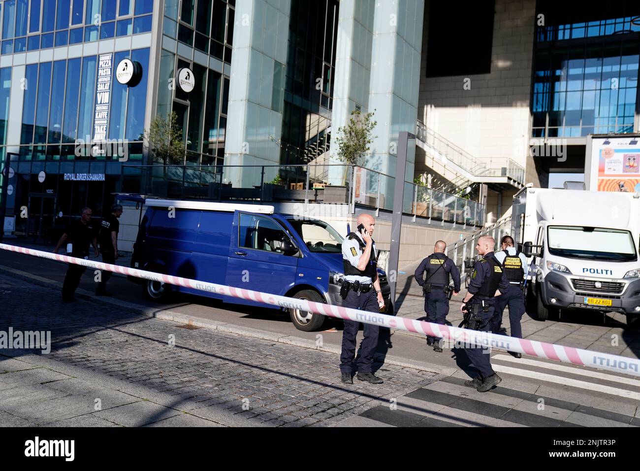 Police investigate the crime scene the day after Sunday's shooting, in ...