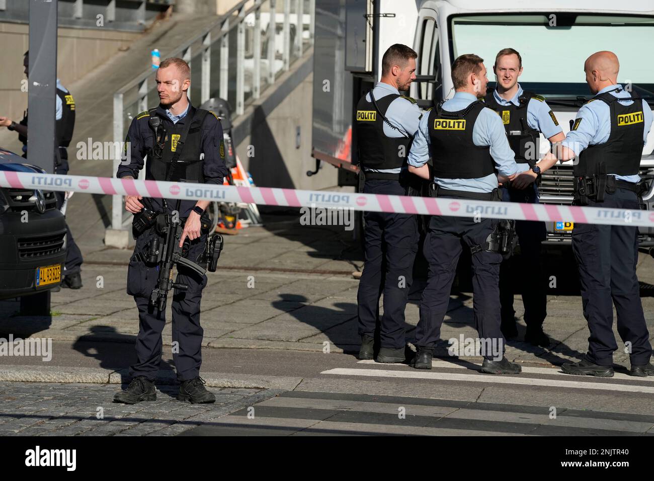 Police investigate the crime scene the day after Sunday's shooting, in ...