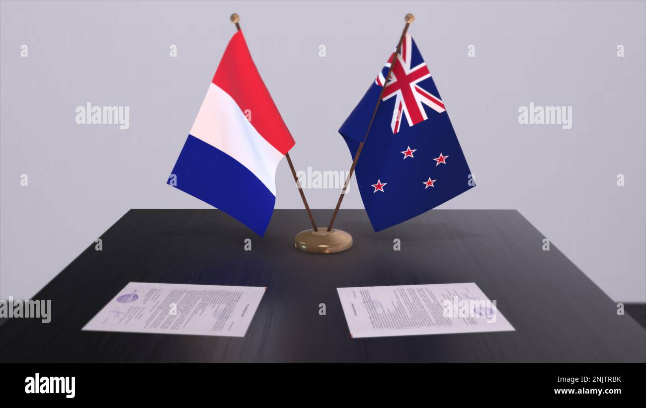 New Zealand and France national flags on table in diplomatic conference ...