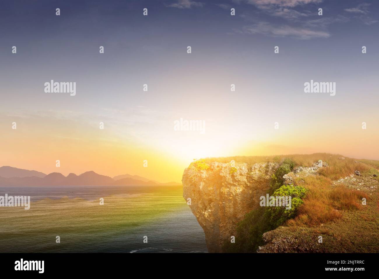Edge of a cliff with ocean view and sunset sky background Stock Photo ...