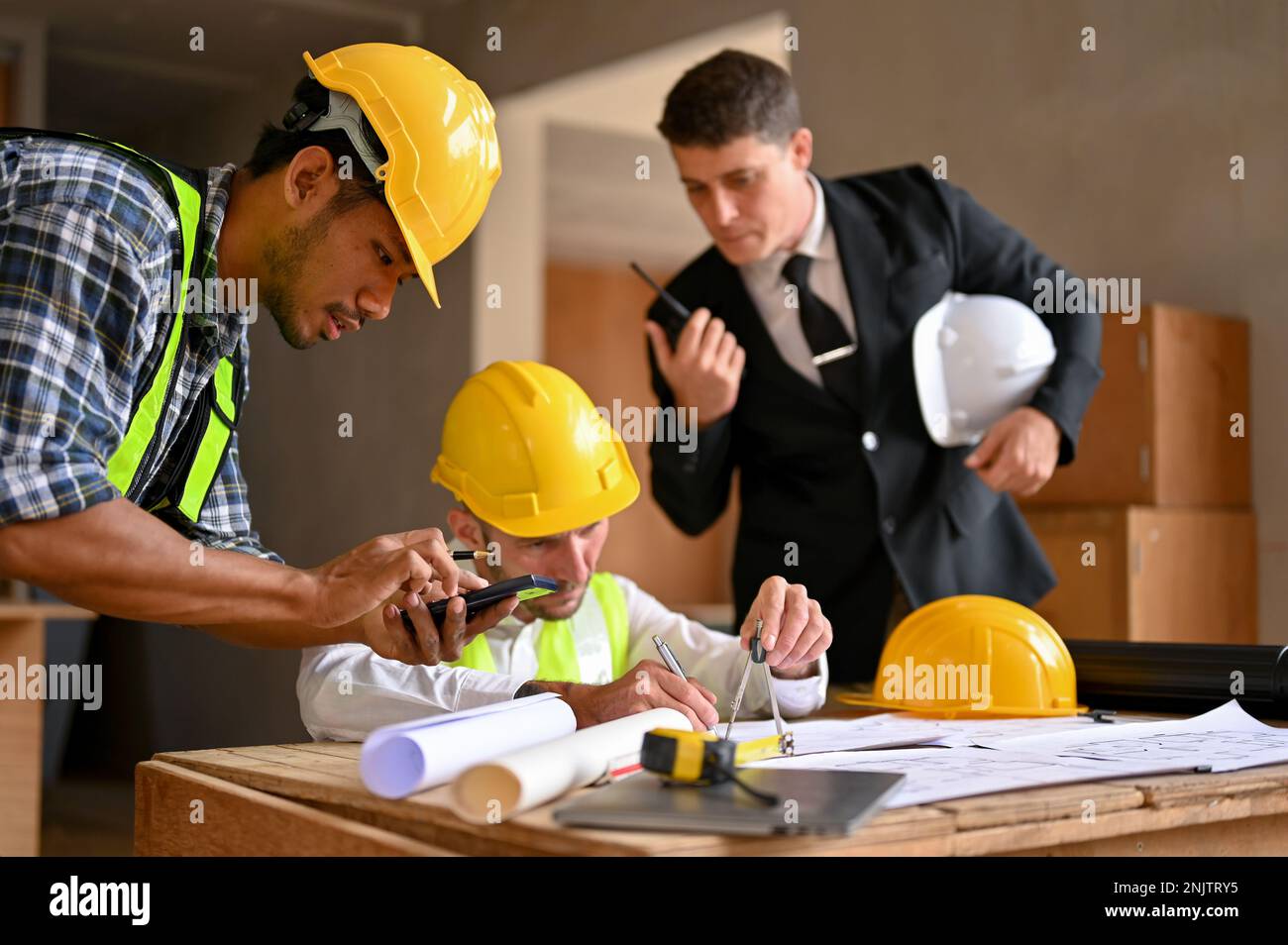 A professional Asian male construction inspector using scientific ...
