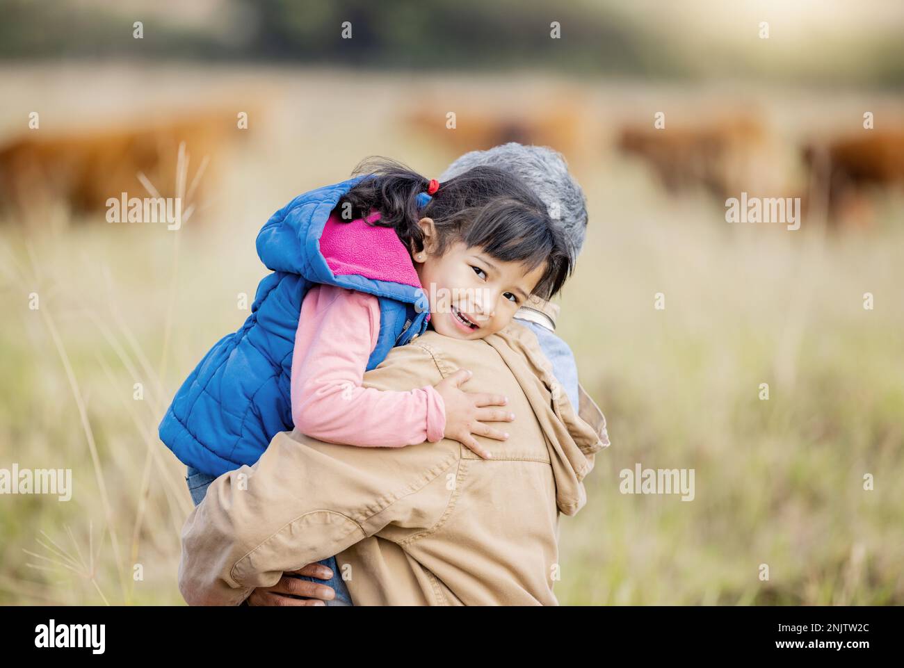Grandmother carrying girl, field portrait and family farm, grass and ...