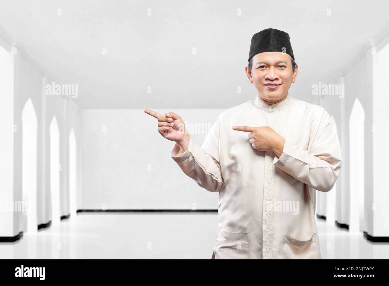 Asian Muslim man pointing to something with a mosque background Stock ...