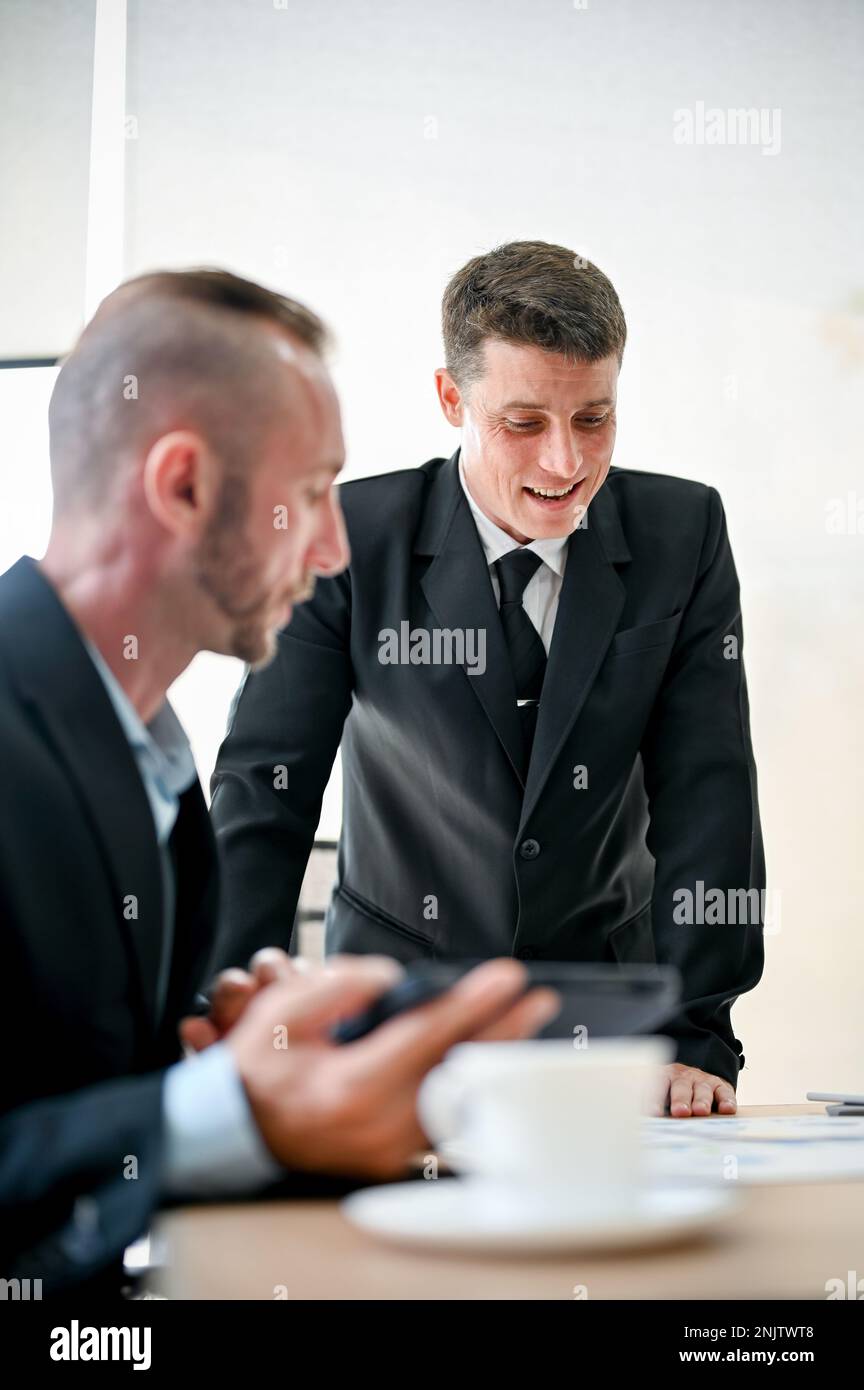Professional and friendly Caucasian boss in a formal business suit is ...