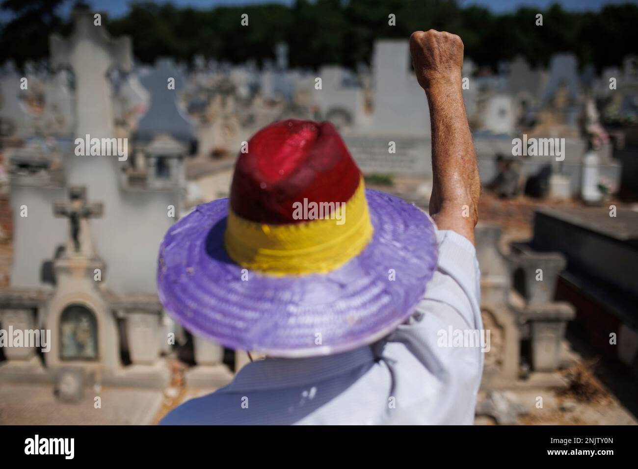 Relatives and family members with their fist raised at the tomb of the ...