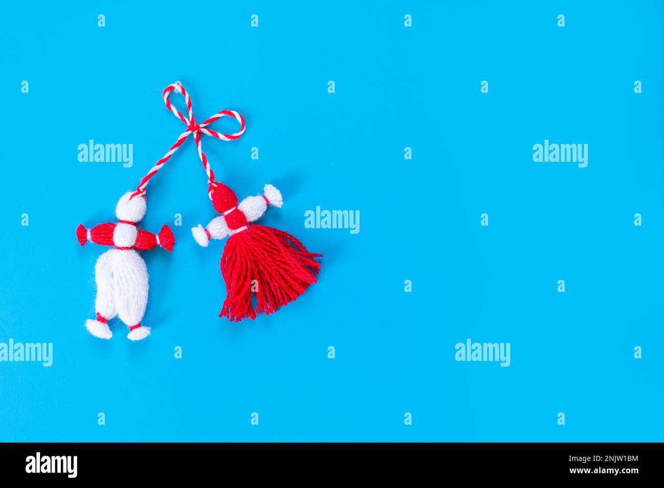 Bulgarian symbol of spring white and red martenitsa on blue background ...