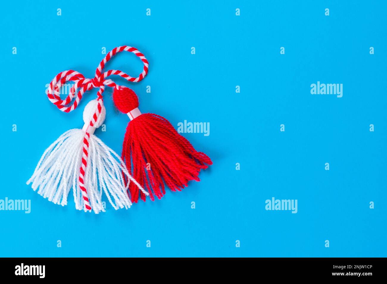 Bulgarian symbol of spring white and red martenitsa on blue background ...