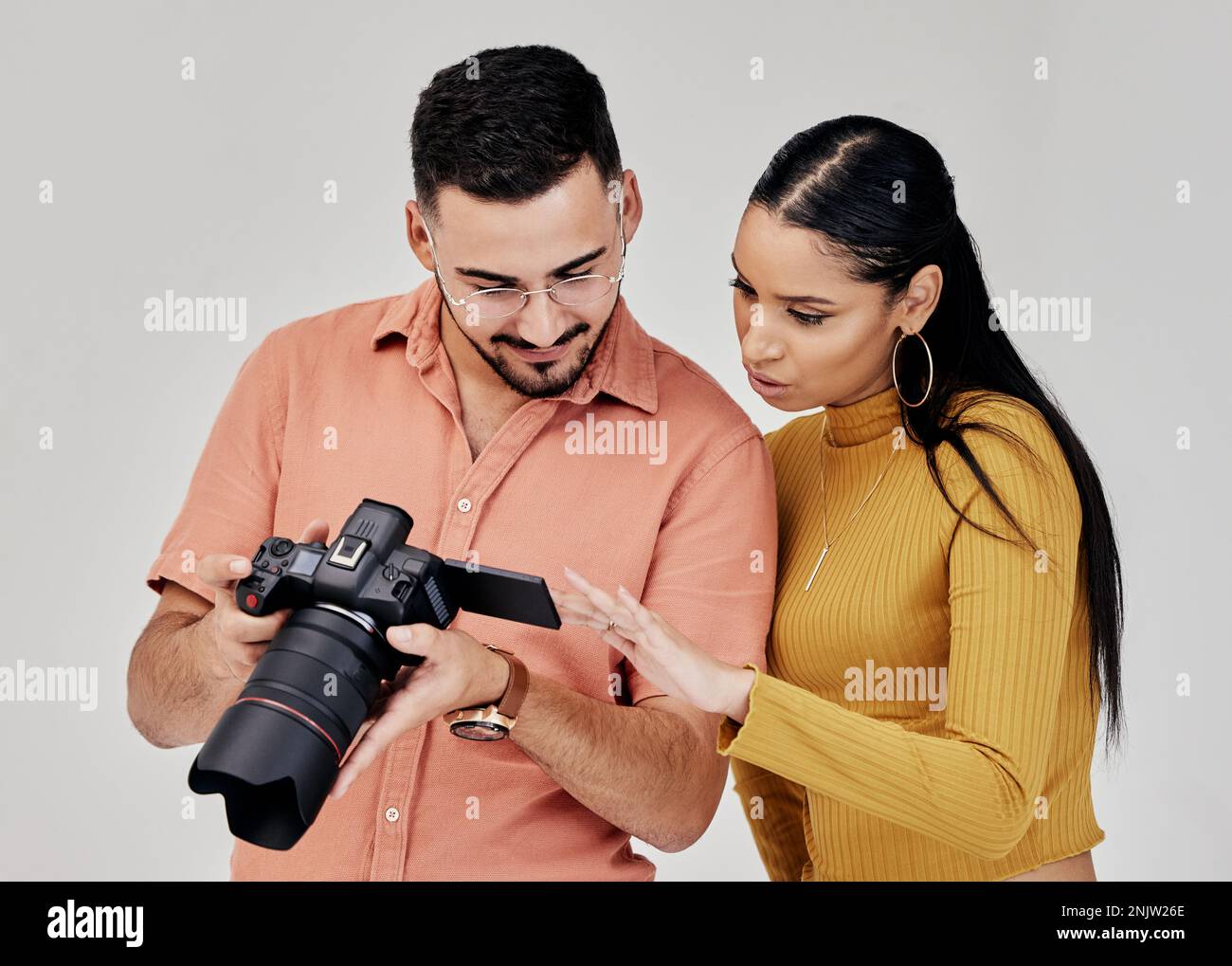 Teamwork, photographer and startup with camera in studio for shoot ...