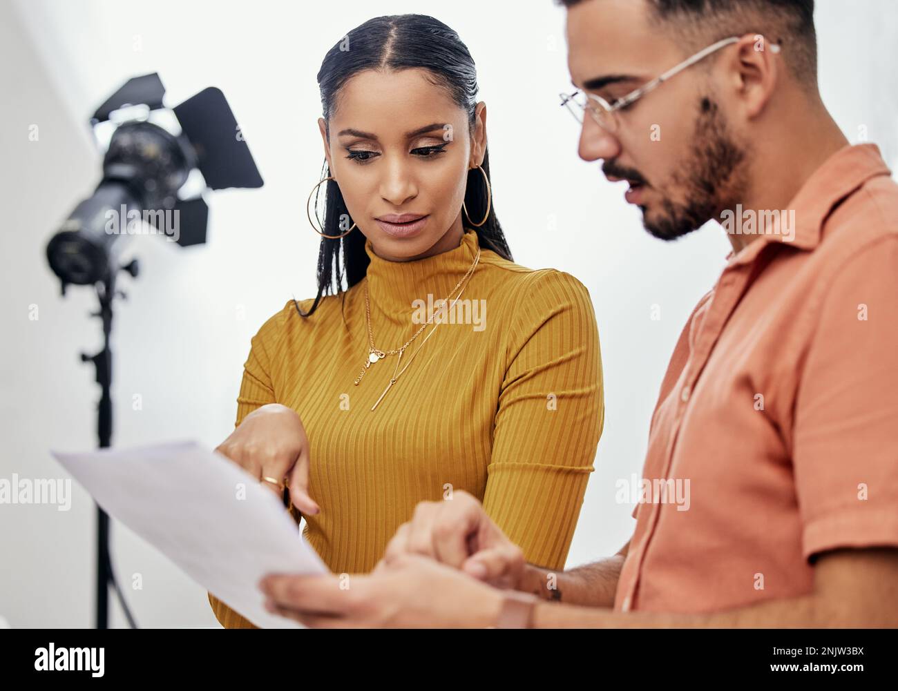 Documents, collaboration or planning with a photographer and model ...