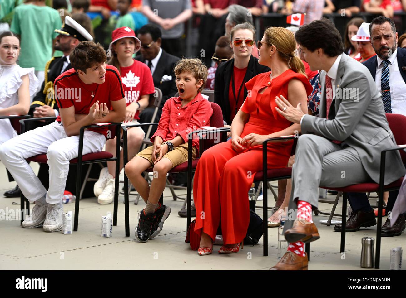 Hadrien Trudeau, center, looks on as he sits with his parents, Canadian ...