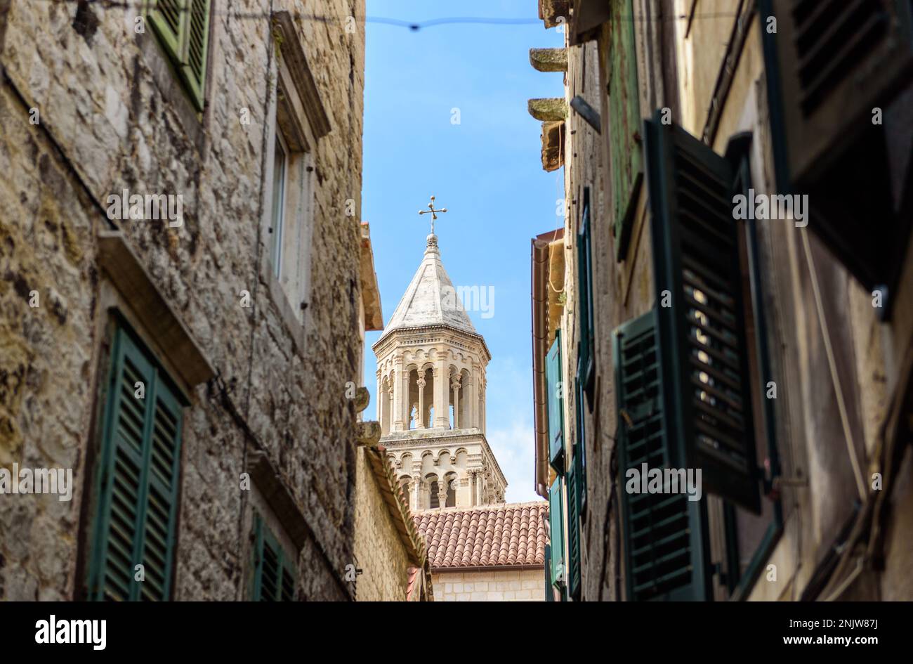 Low angle view of St.Domnius cathedral from narrow streets with stone ...