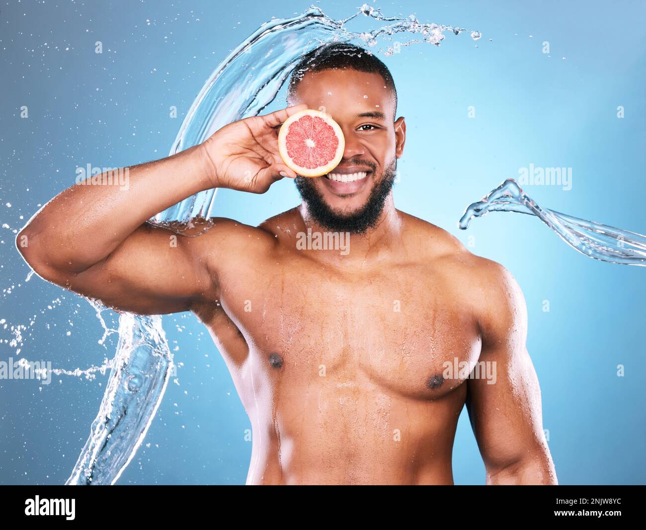 Portrait, water splash or black man with grapefruit for skincare facial cleaning with vitamin c ...