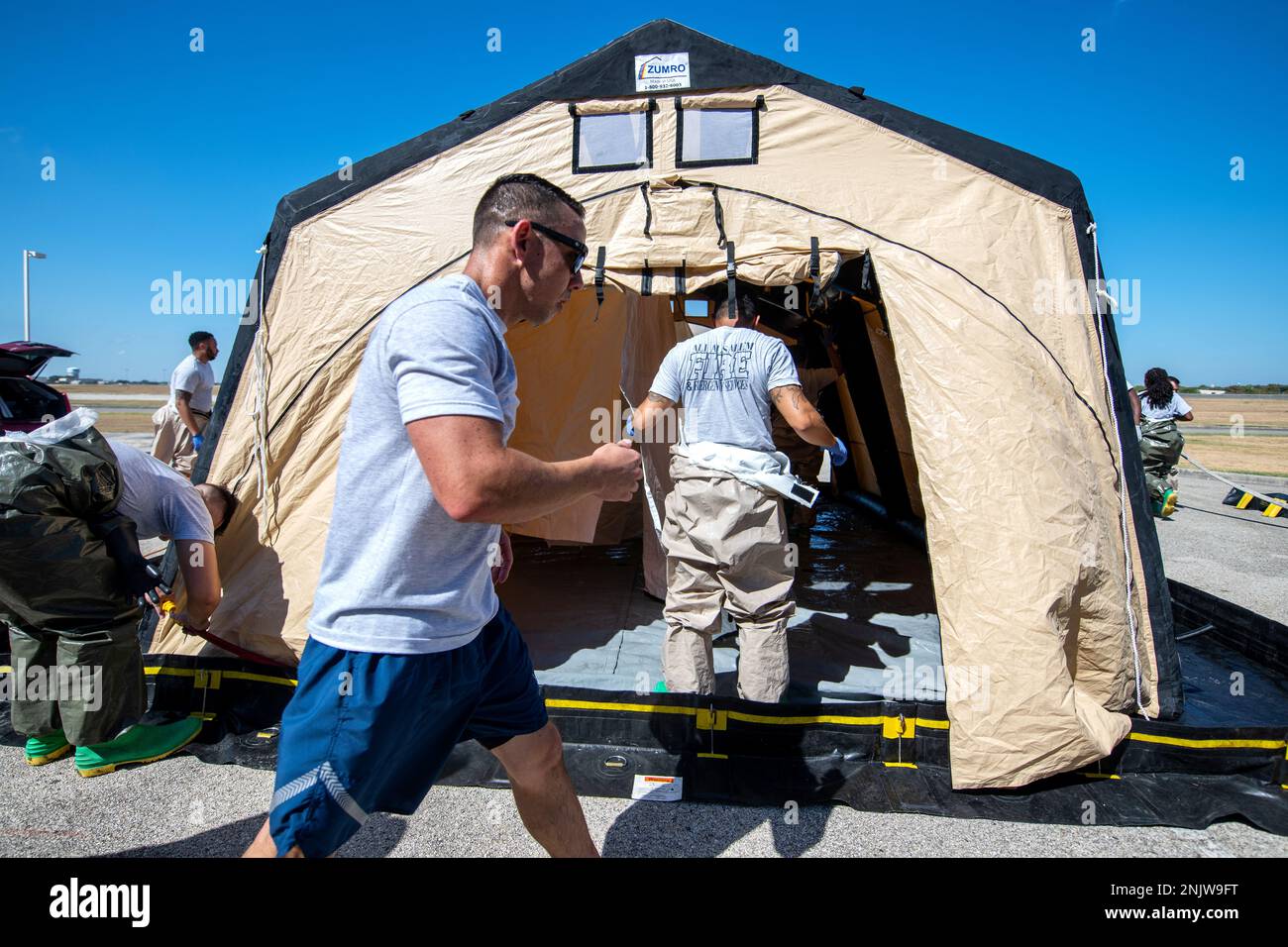 U.S. military members set up a decontamination tent during a Patient ...