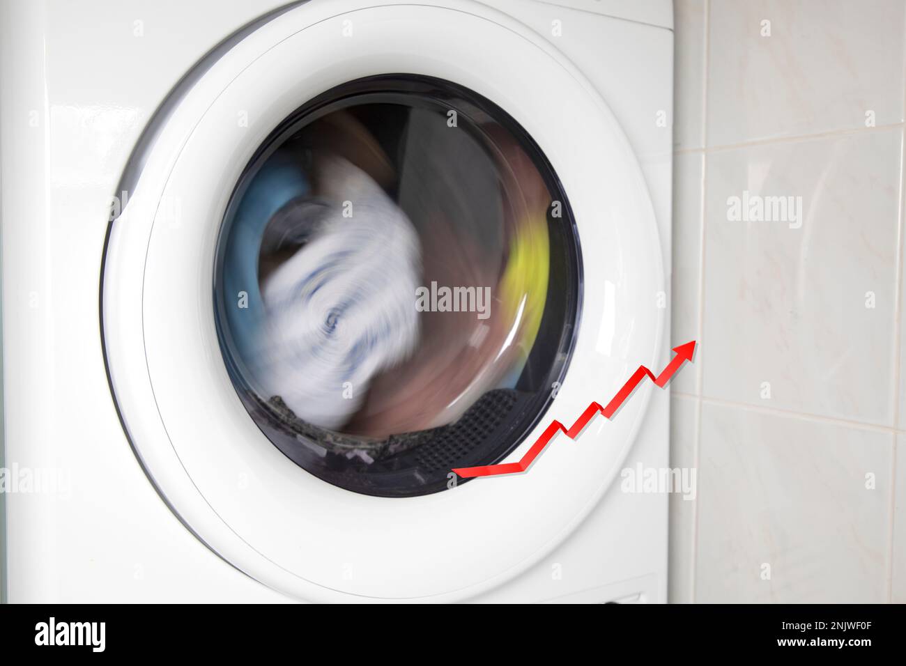 Concept of saving electricity with a washing machine white electrical ...