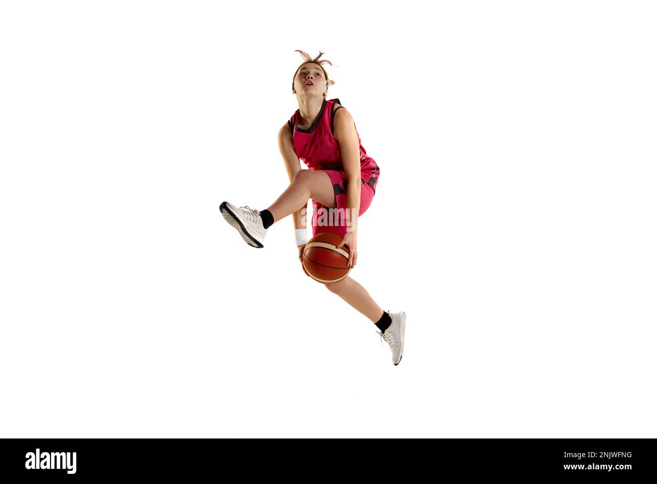 Jump shot. Teen girl, basketball player in action, jumping with ball ...