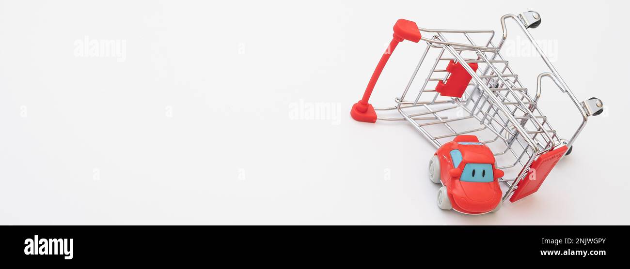 Red car in a shopping cart, isolated on white. car buying concept Stock ...