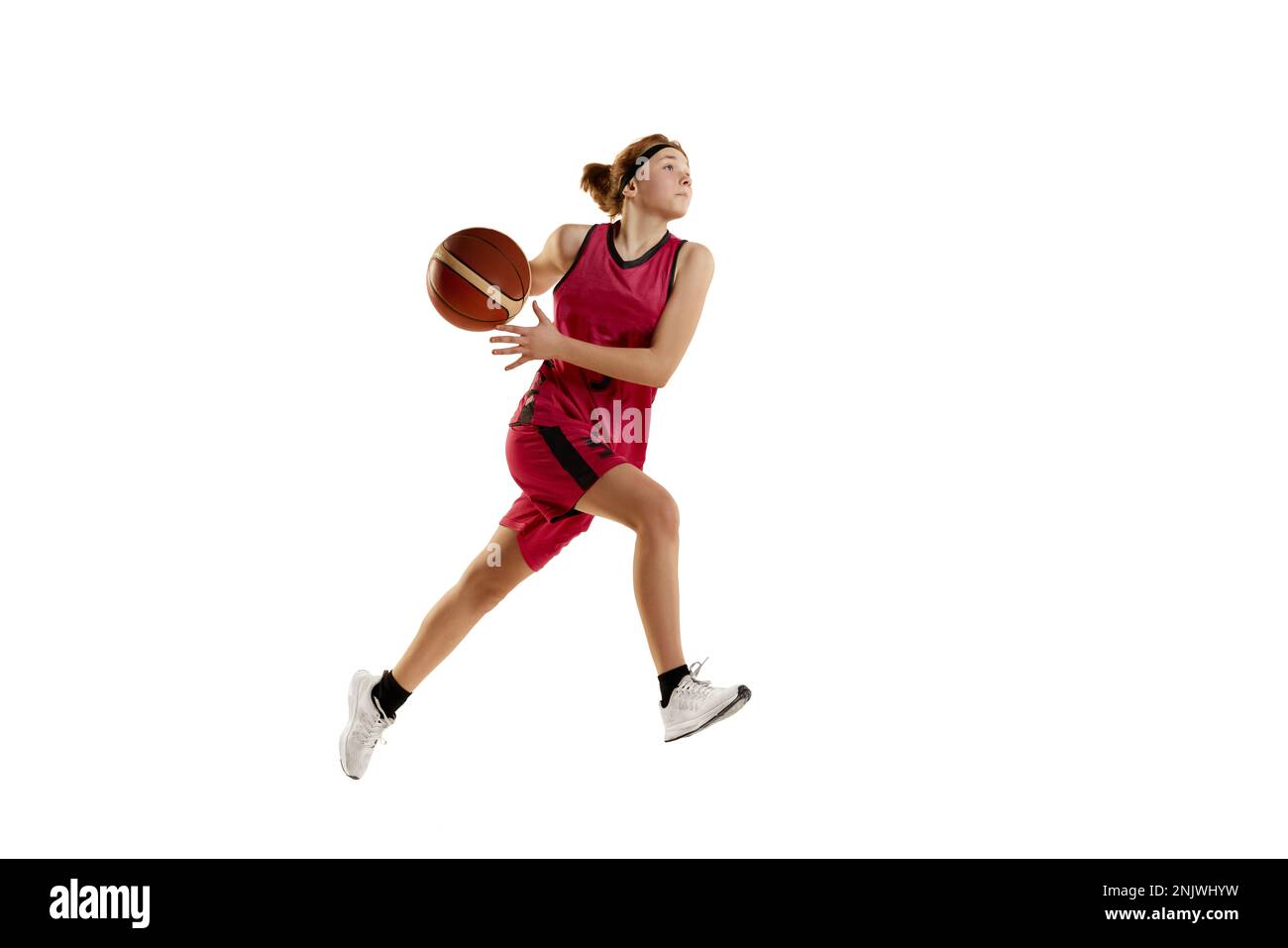 Winning final goal. Teen girl, basketball player in motion, playing ...