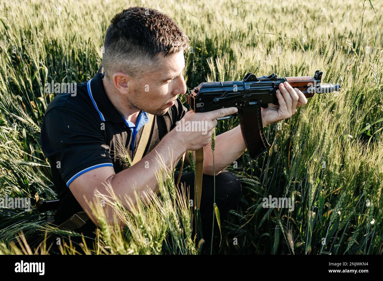 The man in the field with a machine gun, Ukrainian men are preparing ...