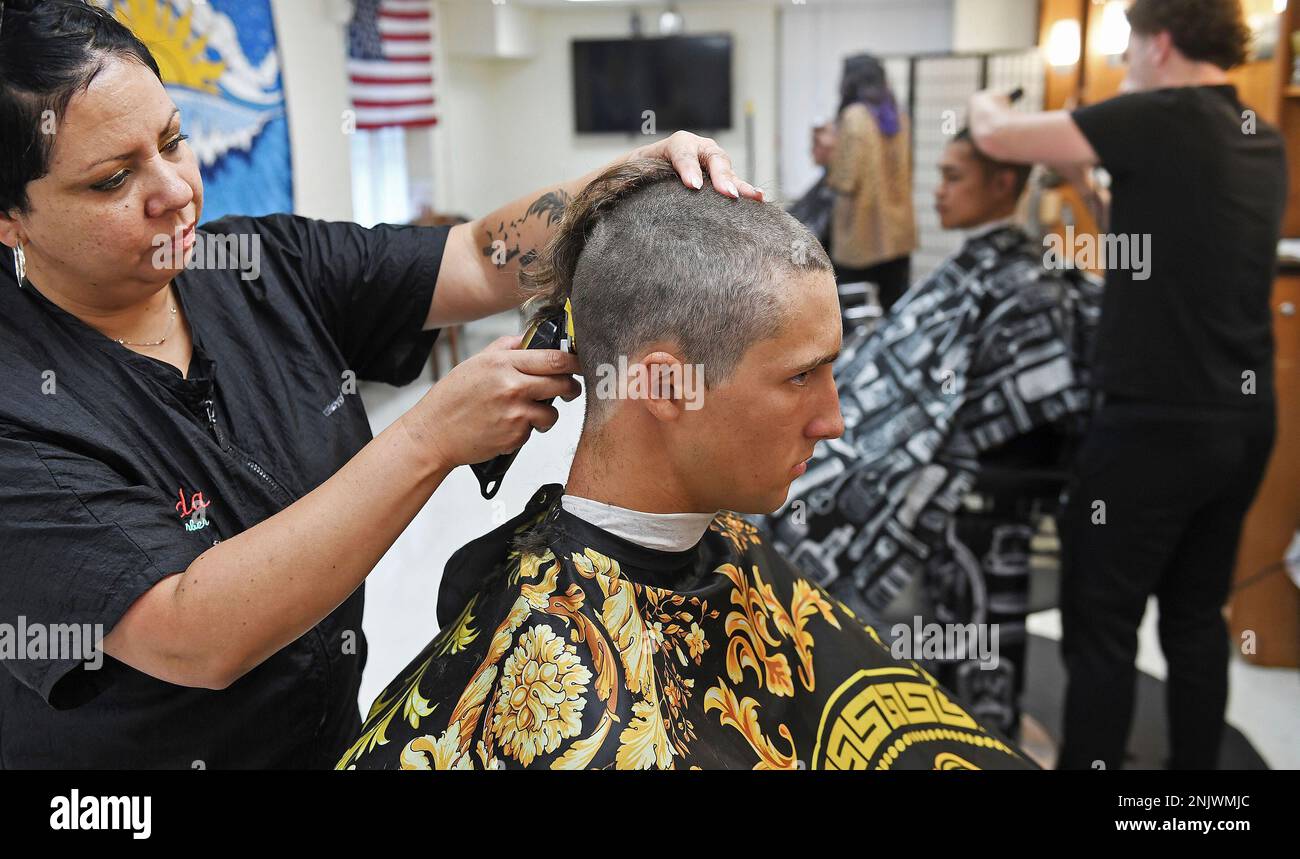 Barber Aida Velazquez gives swab Luke Zylinski a haircut as members of ...