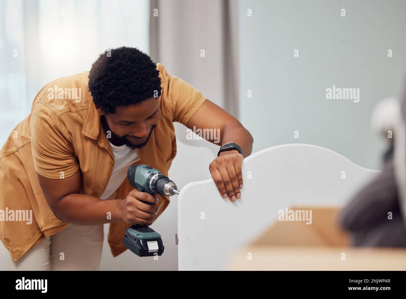 DIY, drill and crib with a black man in his house to build furniture in ...