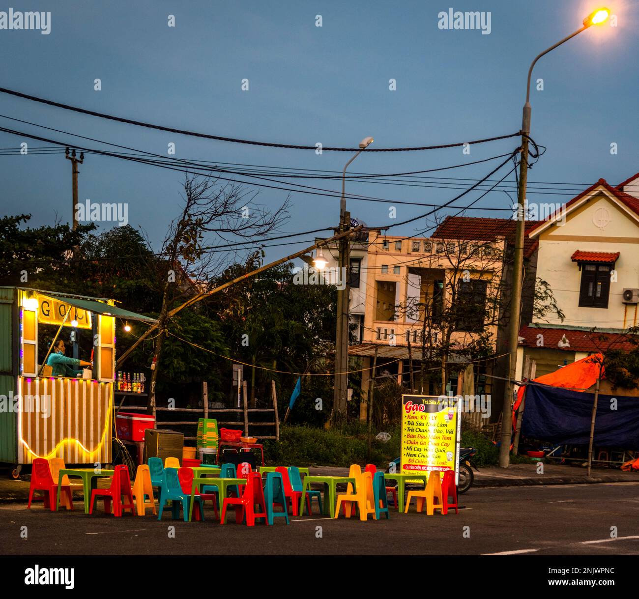 Street food booth in a parking lot with small plastic colorful ...