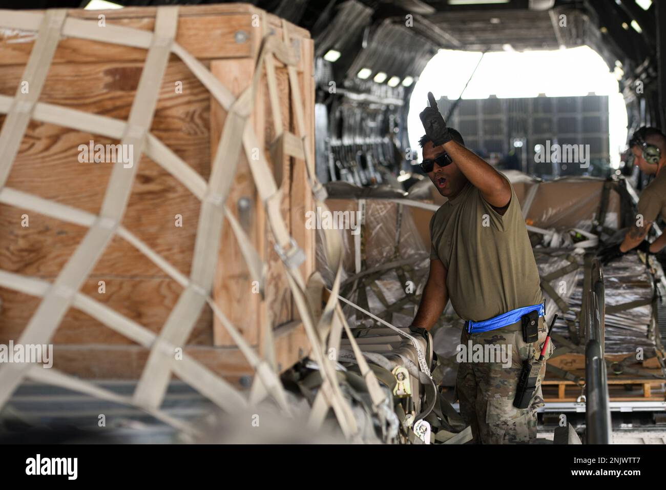 Staff Sgt. Rayan Rahman, a ramp operations supervisor, directs a K ...