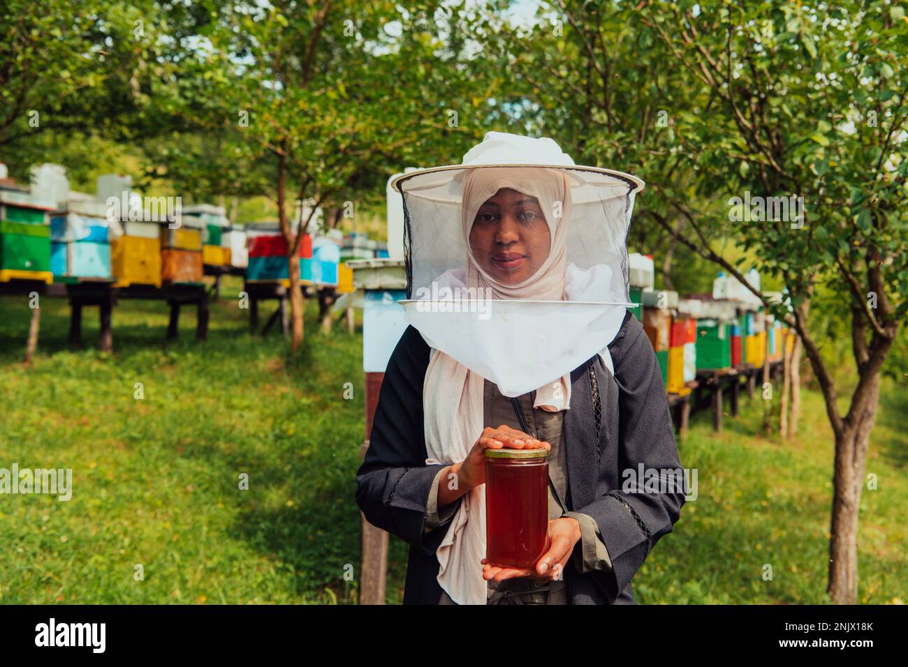 Portrait of a Muslim African American woman in the beekeeping ...