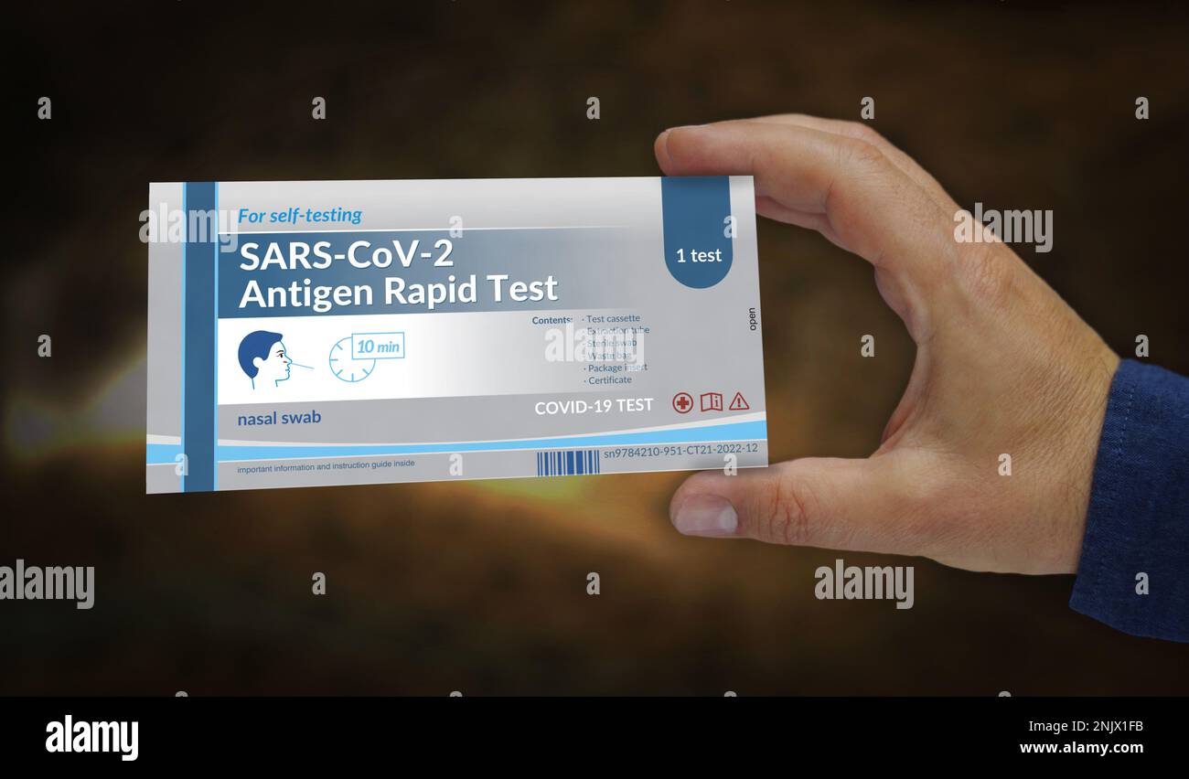 Covid antigen self test box in hand. Rapid coronavirus sars-cov-2 ...