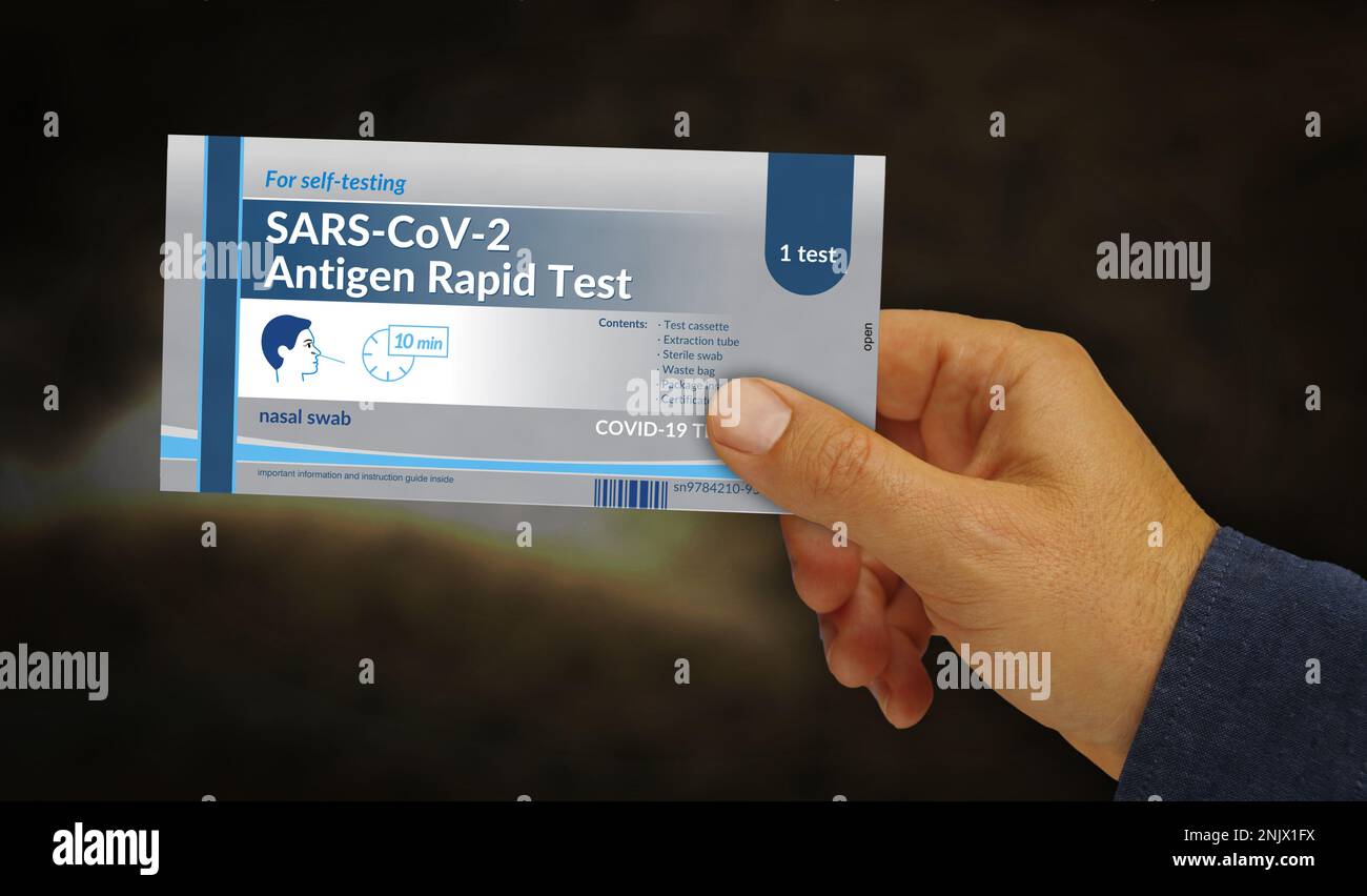 Covid antigen self test box in hand. Rapid coronavirus sars-cov-2 ...