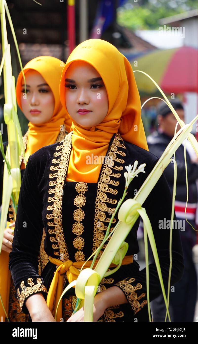 Indonesian with a traditional javanese cloth on 1800 chocolate ketupat ...
