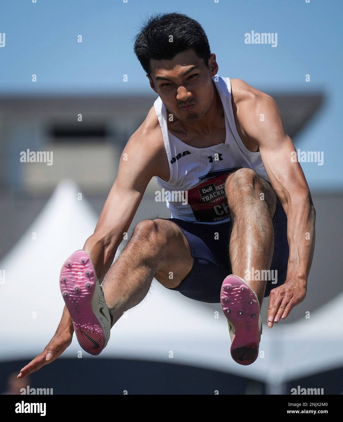 Eric Che competes in the men's long jump finals at the Canadian track ...