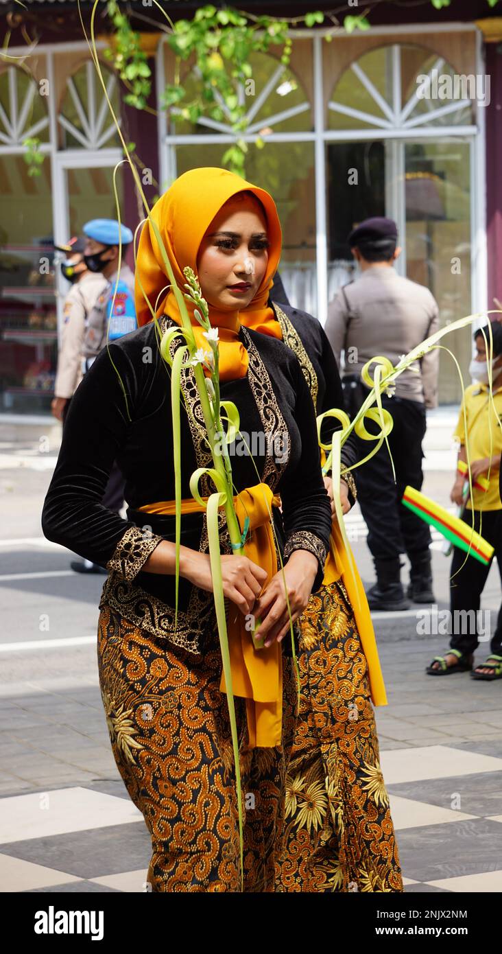 Indonesian with a traditional javanese cloth on 1800 chocolate ketupat ...