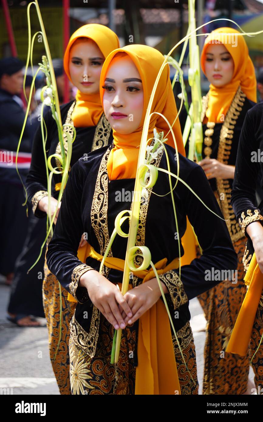 Indonesian with a traditional javanese cloth on 1800 chocolate ketupat ...
