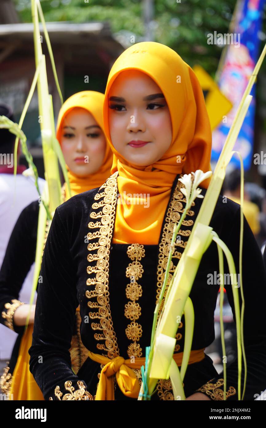 Indonesian with a traditional javanese cloth on 1800 chocolate ketupat ...