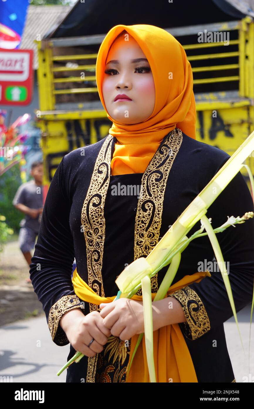 Indonesian with a traditional javanese cloth on 1800 chocolate ketupat ...