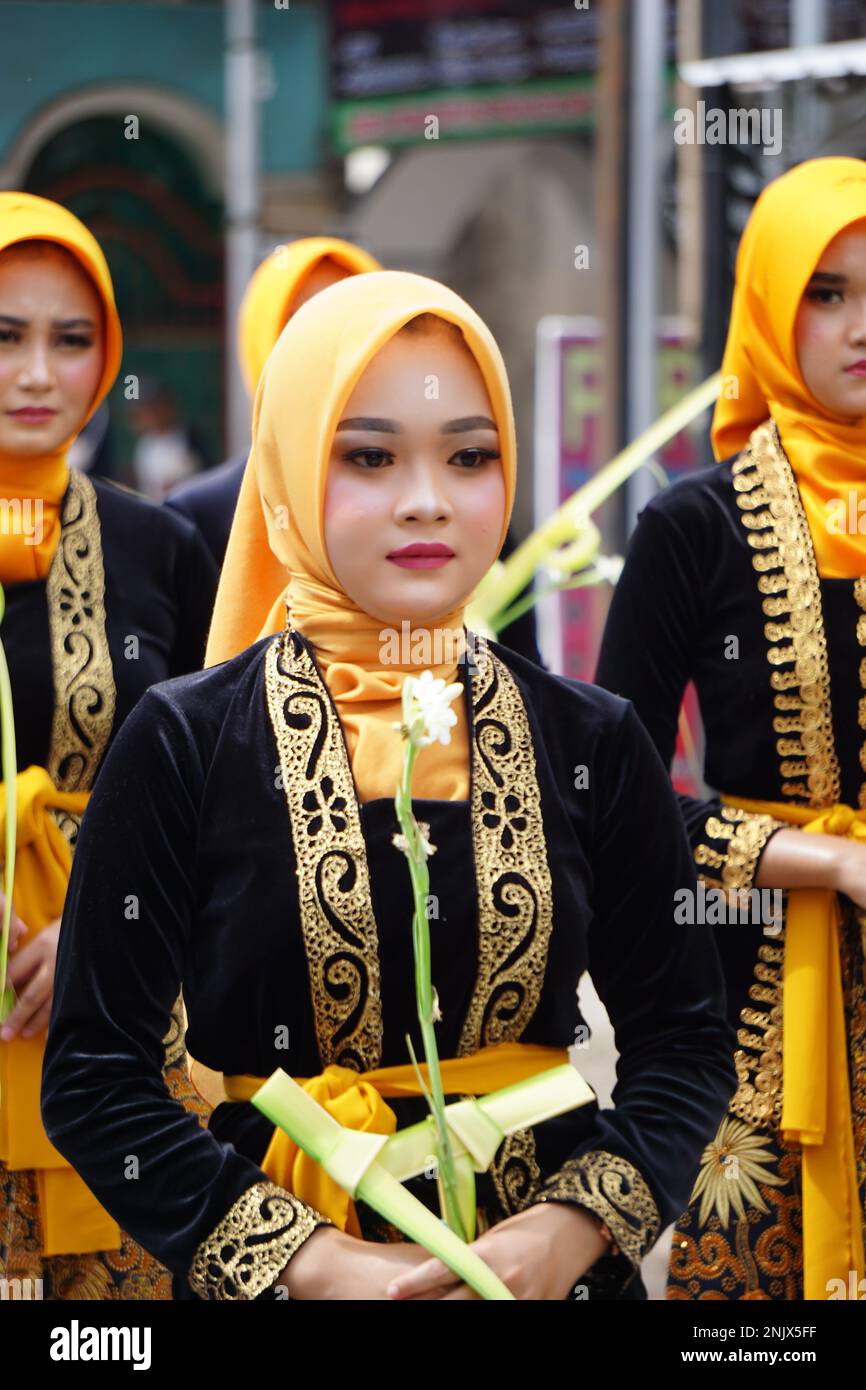 Indonesian with a traditional javanese cloth on 1800 chocolate ketupat ...