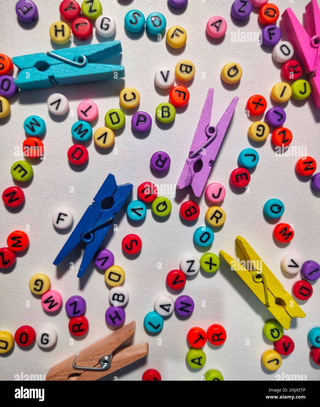 Colorful alphabet and number beads on white background Stock Photo - Alamy