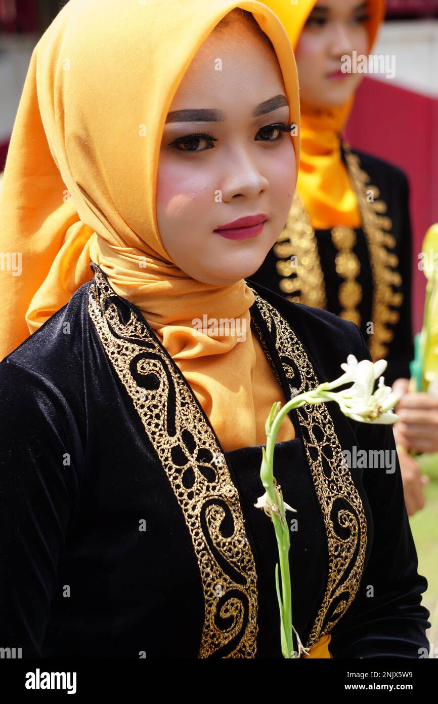 Indonesian with a traditional javanese cloth on 1800 chocolate ketupat ...