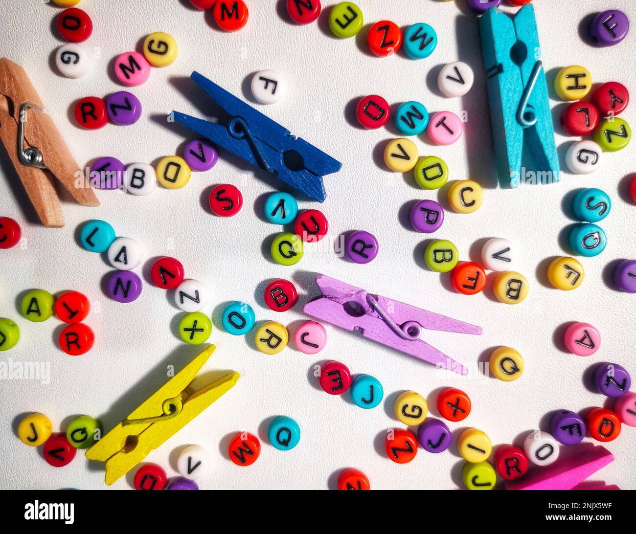 Colorful alphabet and number beads on white background Stock Photo - Alamy