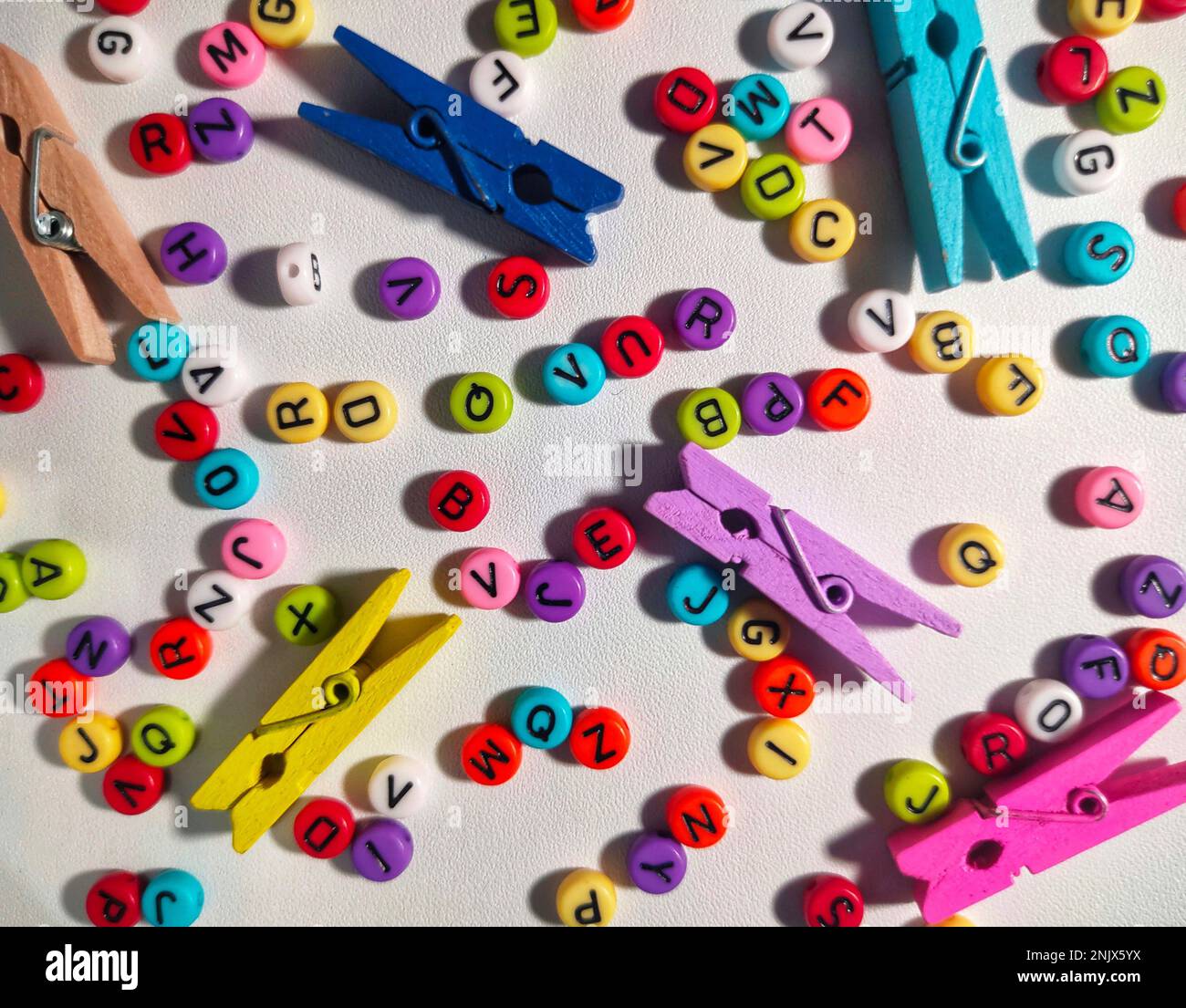 Colorful alphabet and number beads on white background Stock Photo - Alamy
