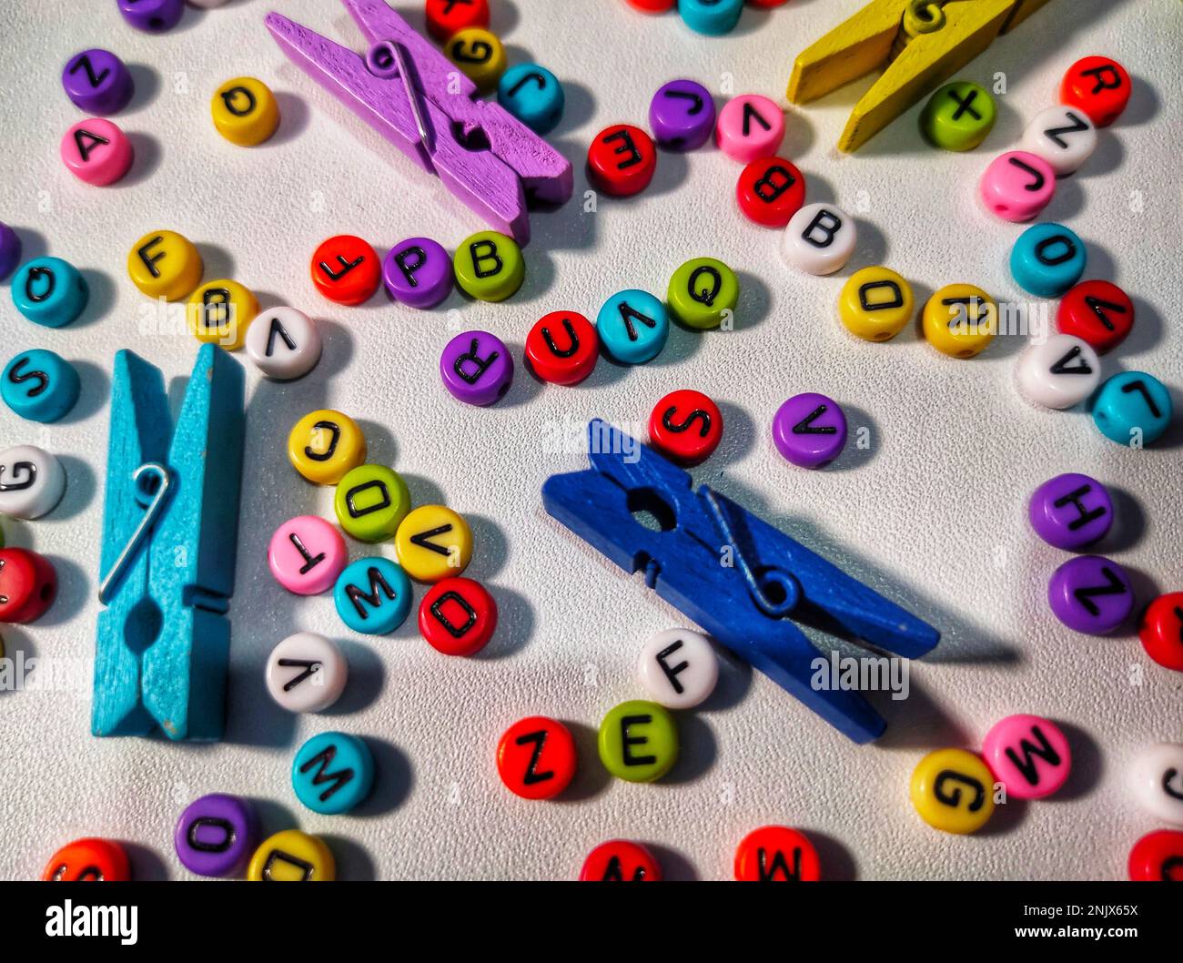 Colorful alphabet and number beads on white background Stock Photo - Alamy