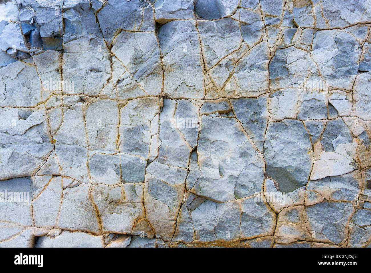 Abstract natural background made of cracked rocks creating a unique and ...
