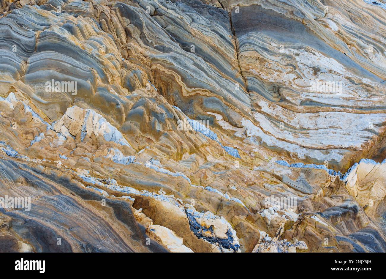 Natural backdrop of layered rocks in mesmerizing shades of gold and ...