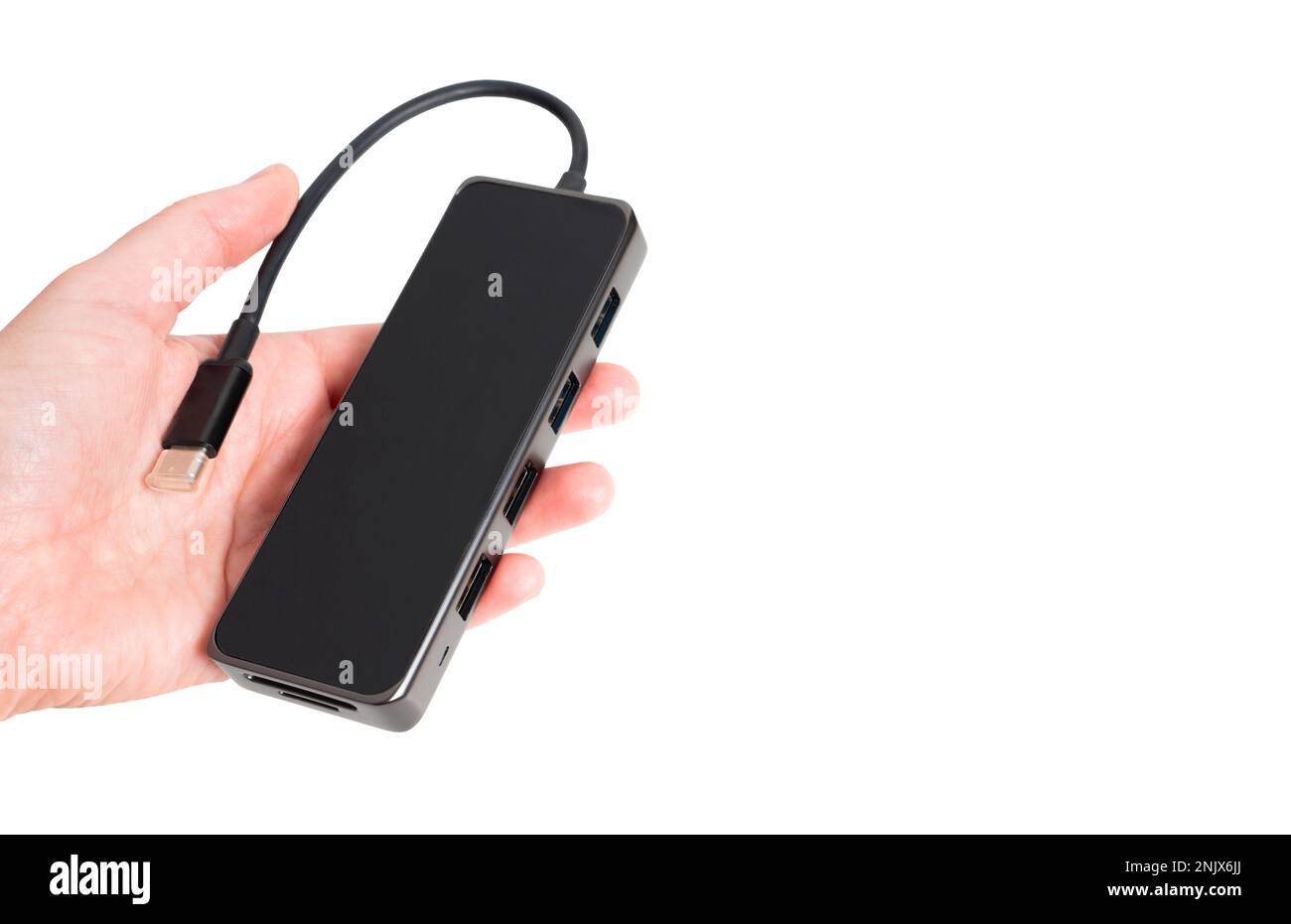 Hand holding a black aluminum multiport usb-c hub adapter isolated on ...