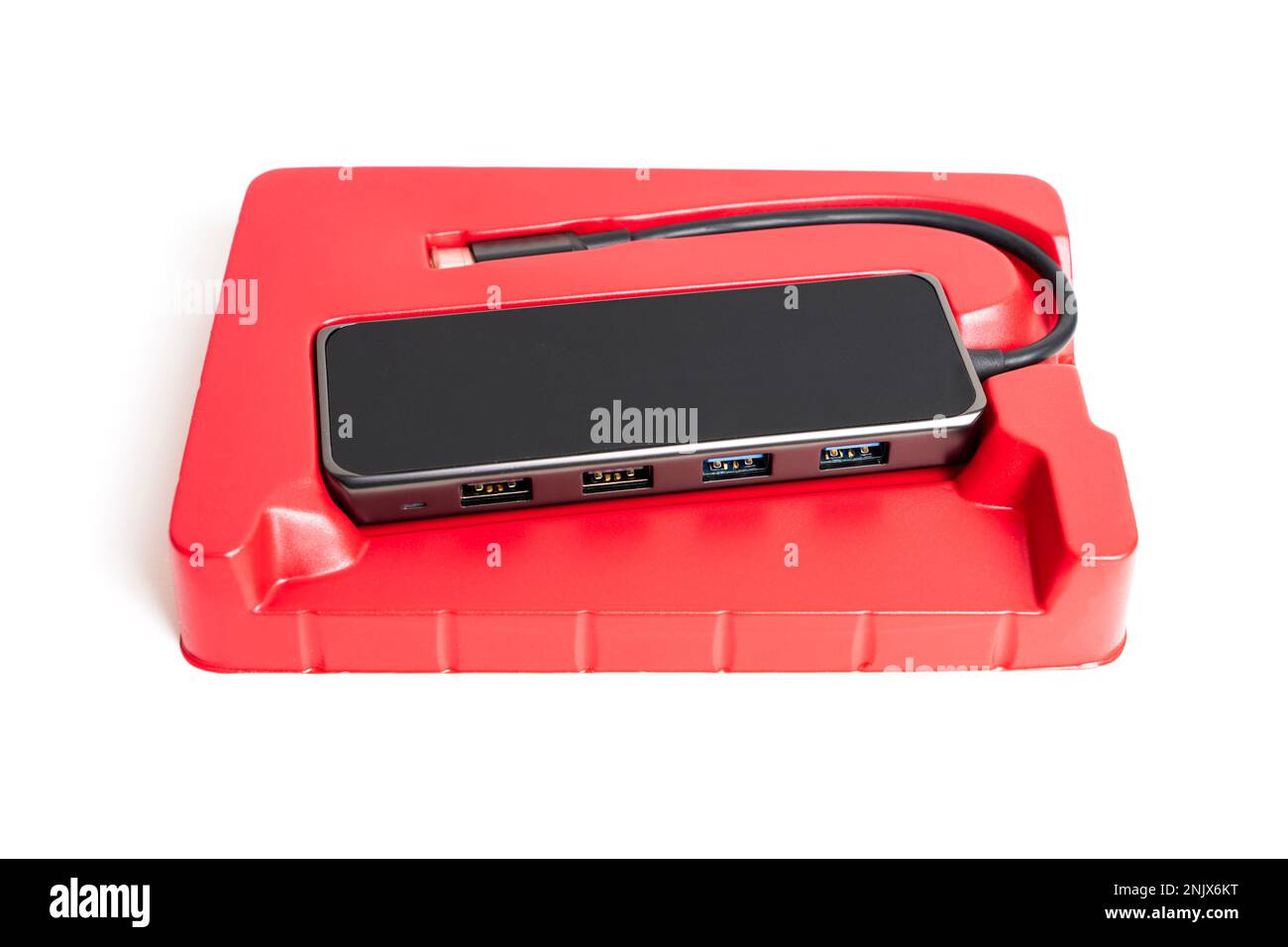 Multiport USB-C hub packaged in a vibrant red retail box, isolated on a ...