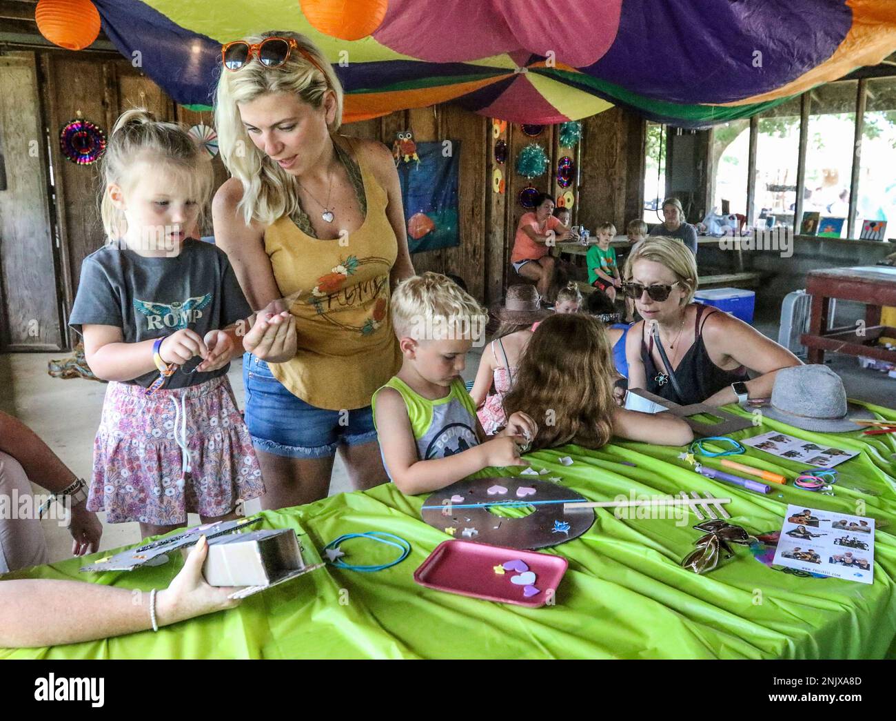 Leslie Burch, second from left, and April Jernigan, right, work with ...